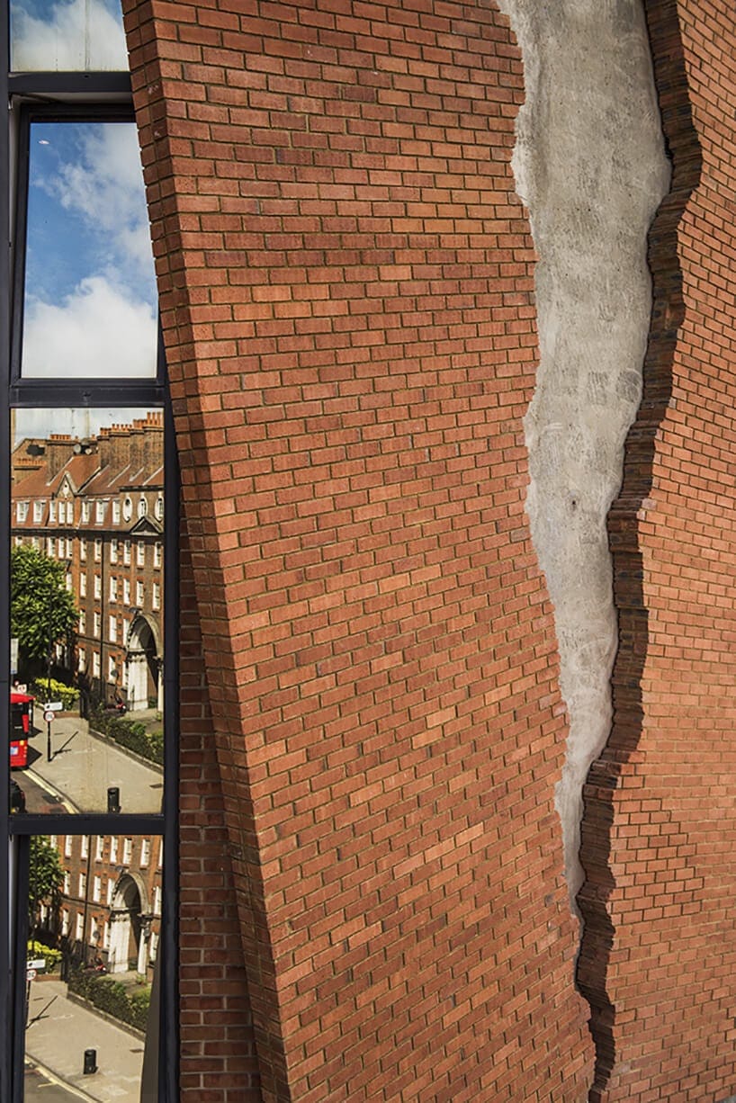 Alex Chinneck Cracks the Front of Brick Building in London - FREEYORK